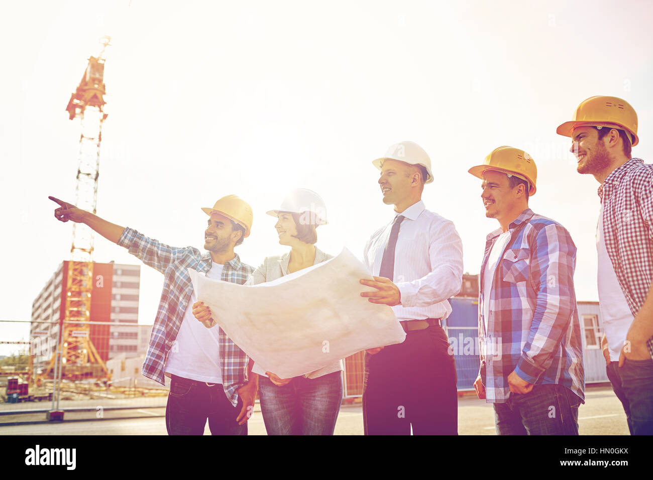 group of builders and architects with blueprint Stock Photo - Alamy