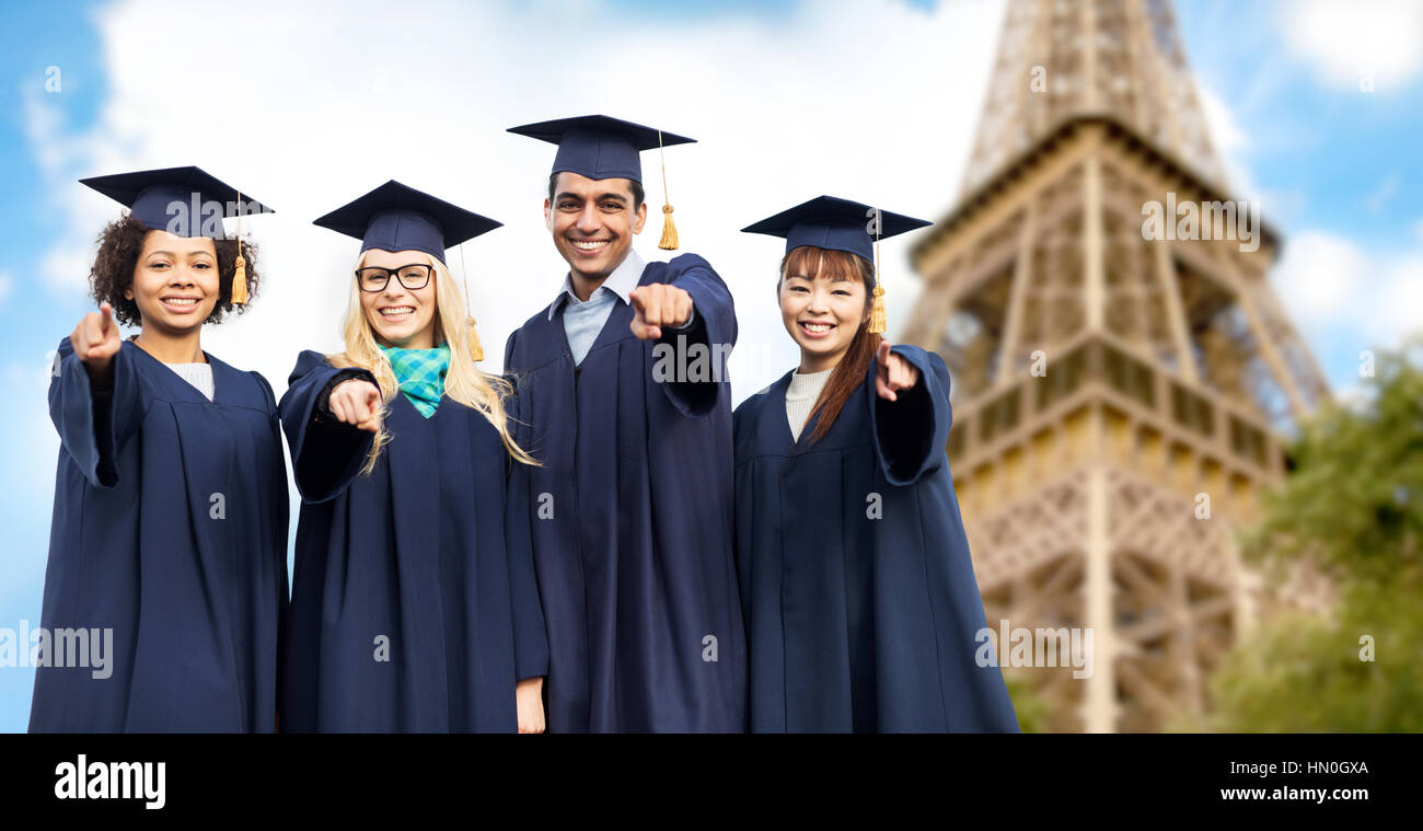 happy bachelors pointing at you over eiffel tower Stock Photo - Alamy
