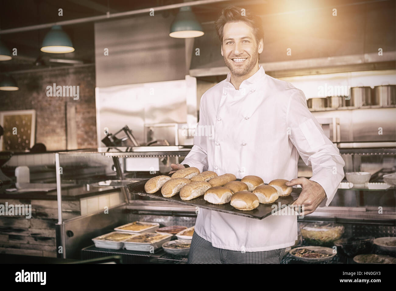 Happy baker showing tray hi-res stock photography and images - Alamy