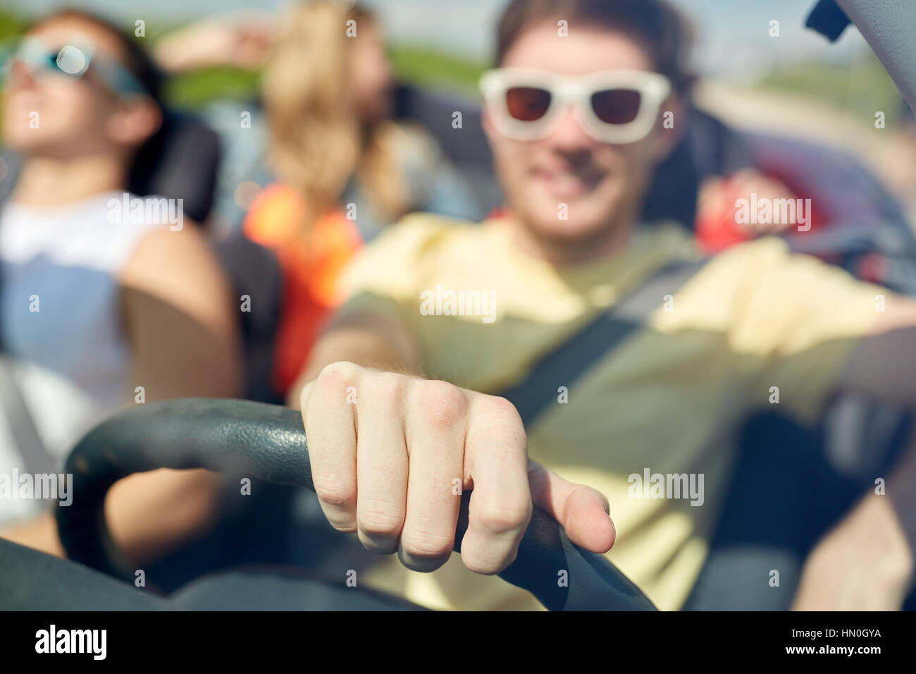 happy friends driving in convertible car Stock Photo - Alamy