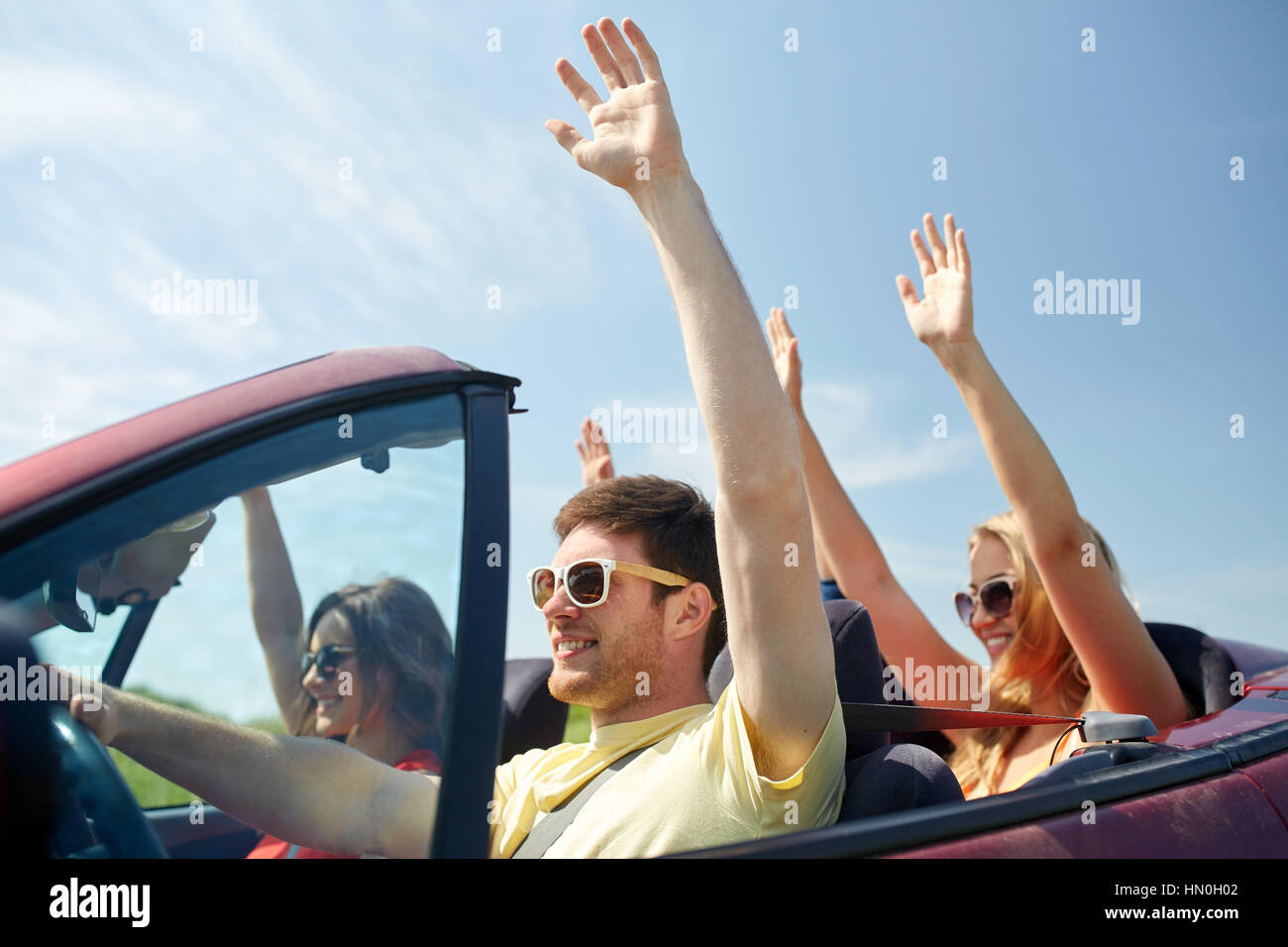 happy friends driving in cabriolet car at country Stock Photo - Alamy
