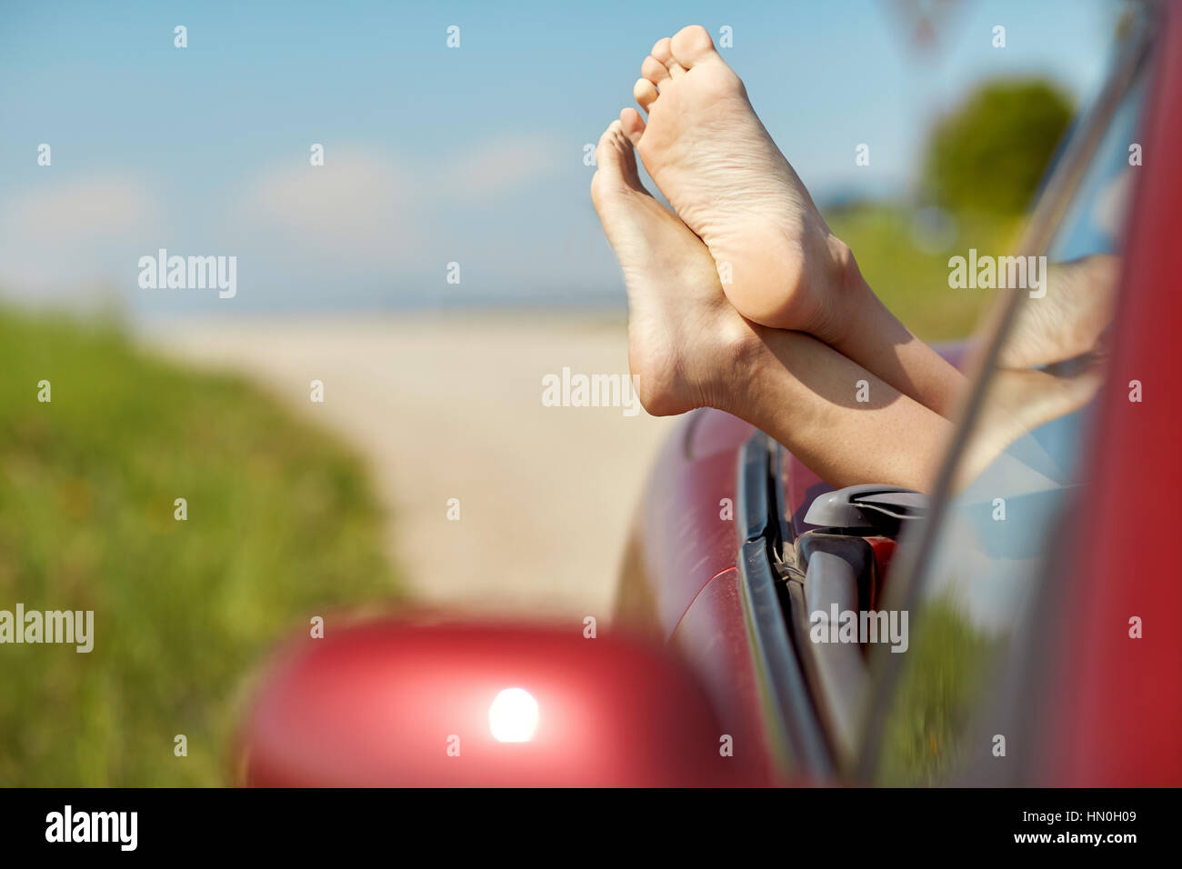 feet of young woman in convertible car at summer Stock Photo - Alamy