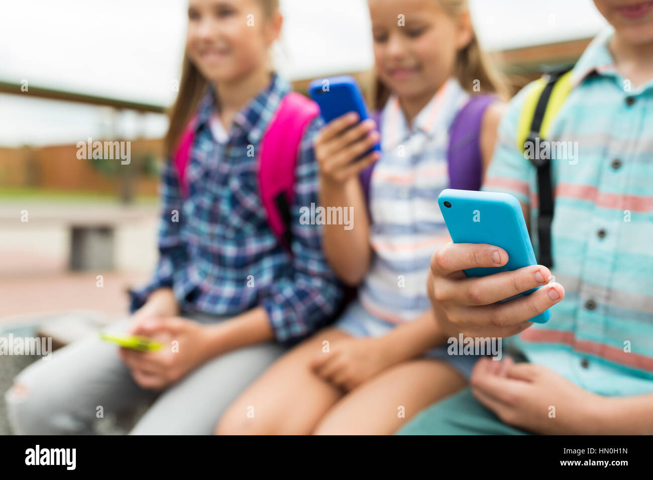 elementary school students with smartphones Stock Photo - Alamy
