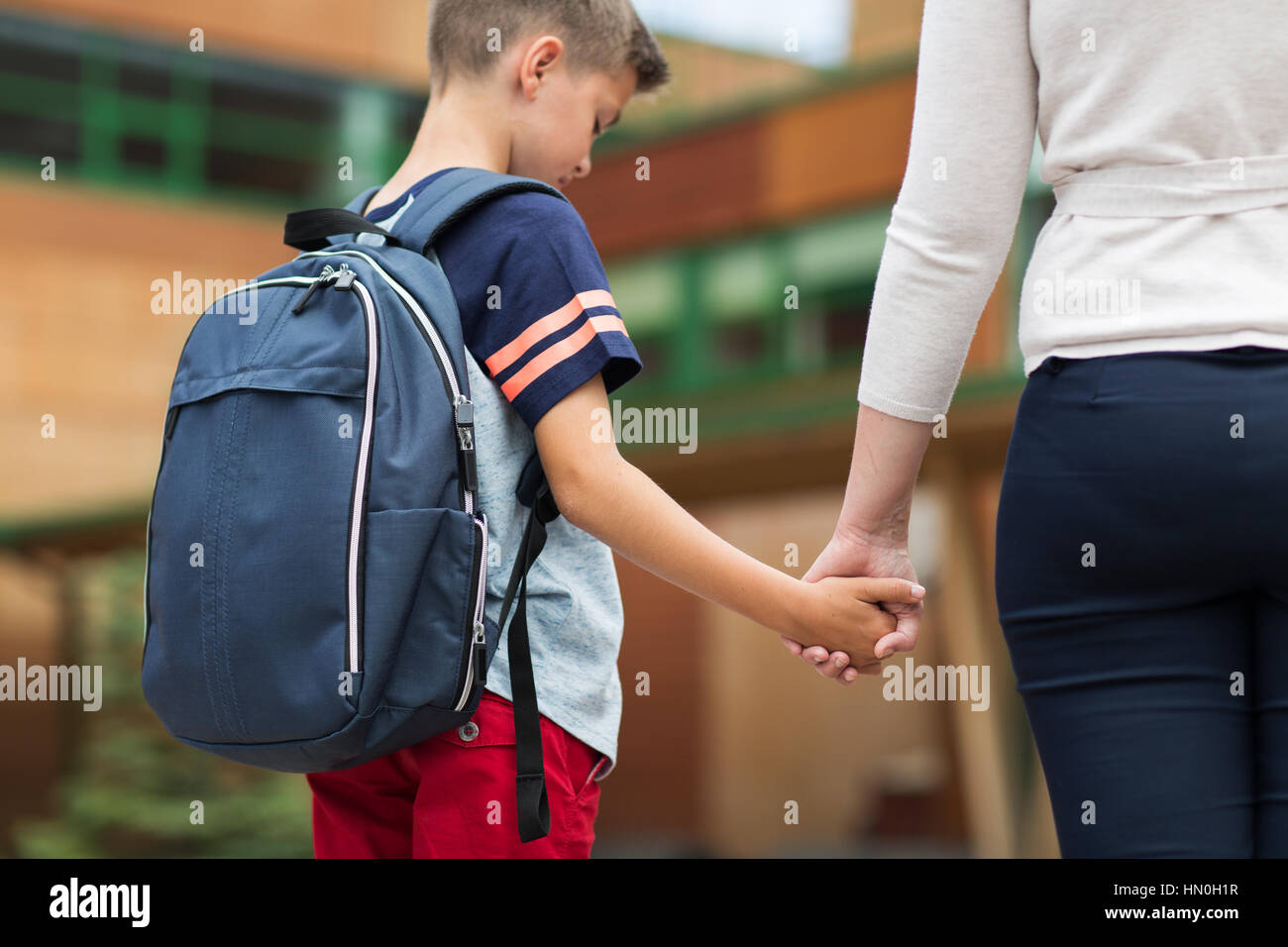 elementary student boy with mother at school yard Stock Photo - Alamy
