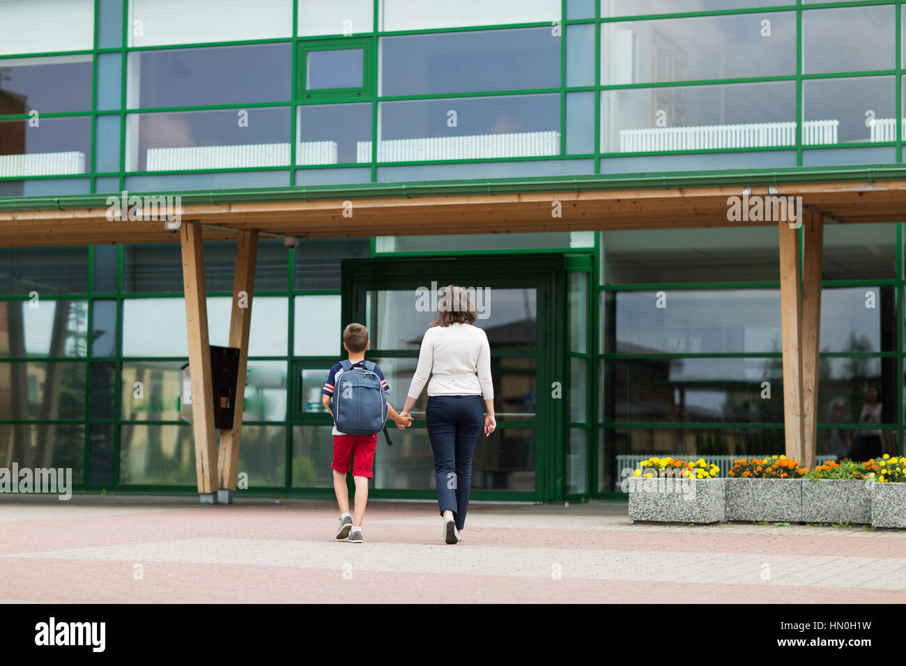 elementary student boy with mother going to school Stock Photo - Alamy
