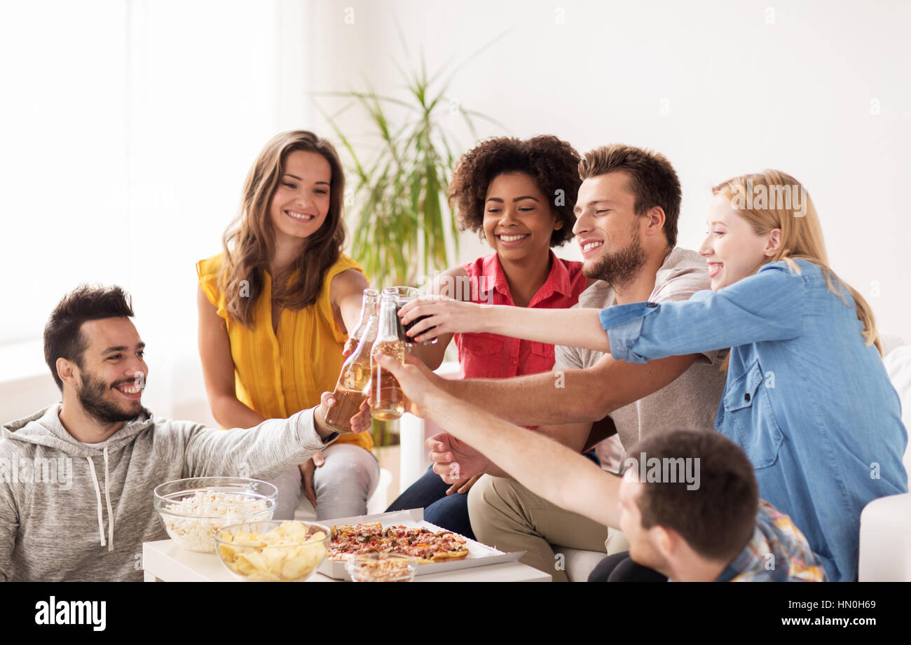 friends having party and clinking drinks at home Stock Photo - Alamy
