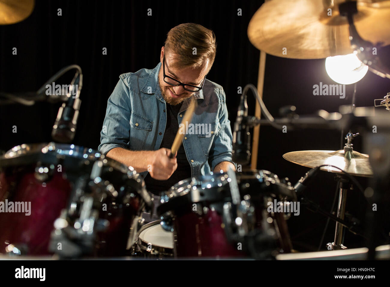 male musician playing drums and cymbals at concert Stock Photo - Alamy