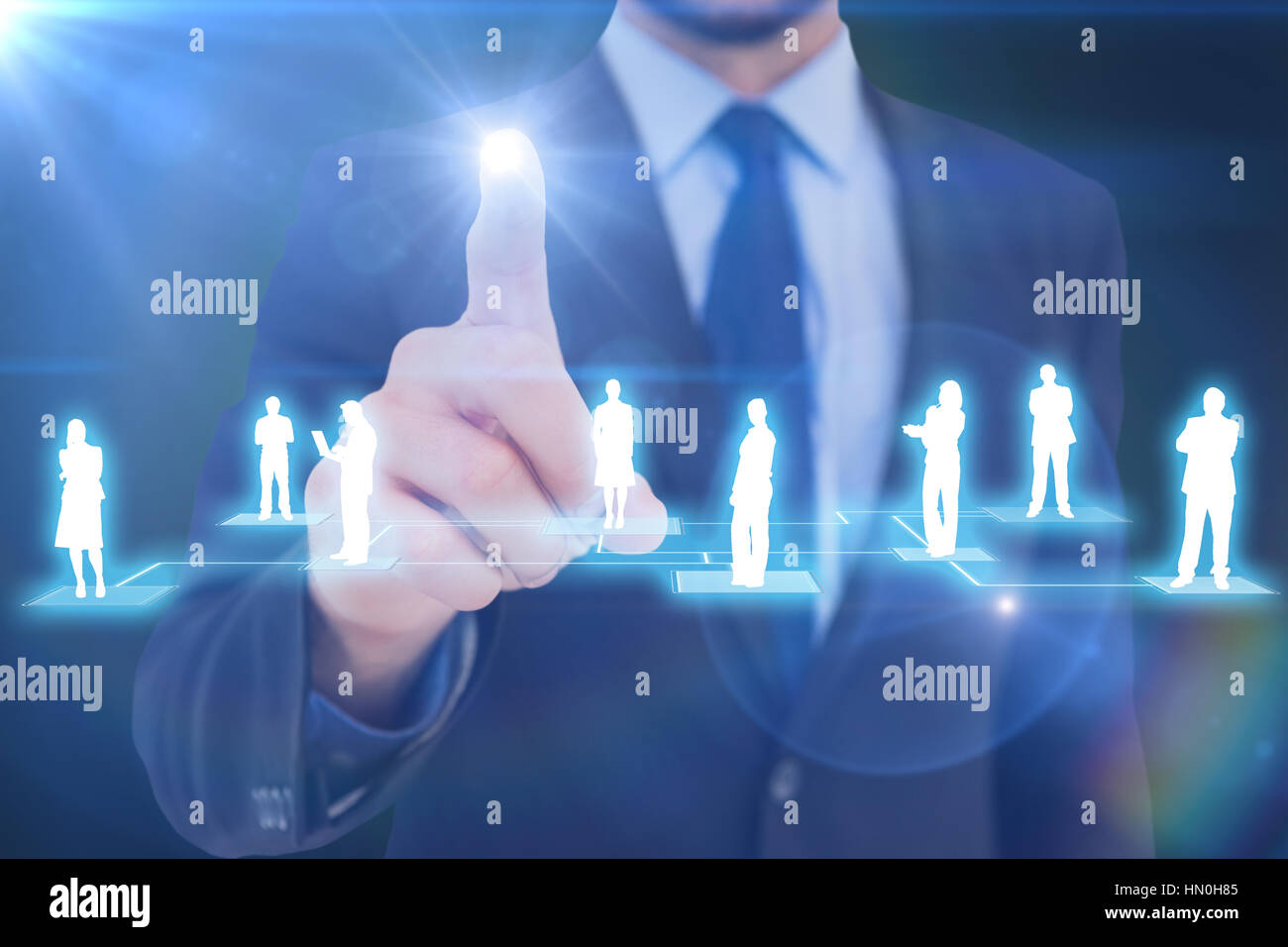 Businessman pointing his finger at camera against blue background with ...