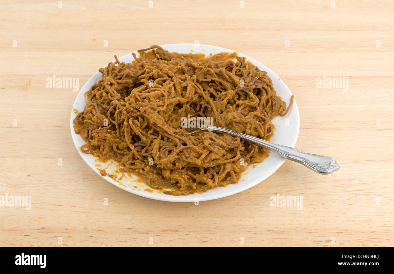 A serving of soybean spaghetti with tomato sauce on a plate with a ...