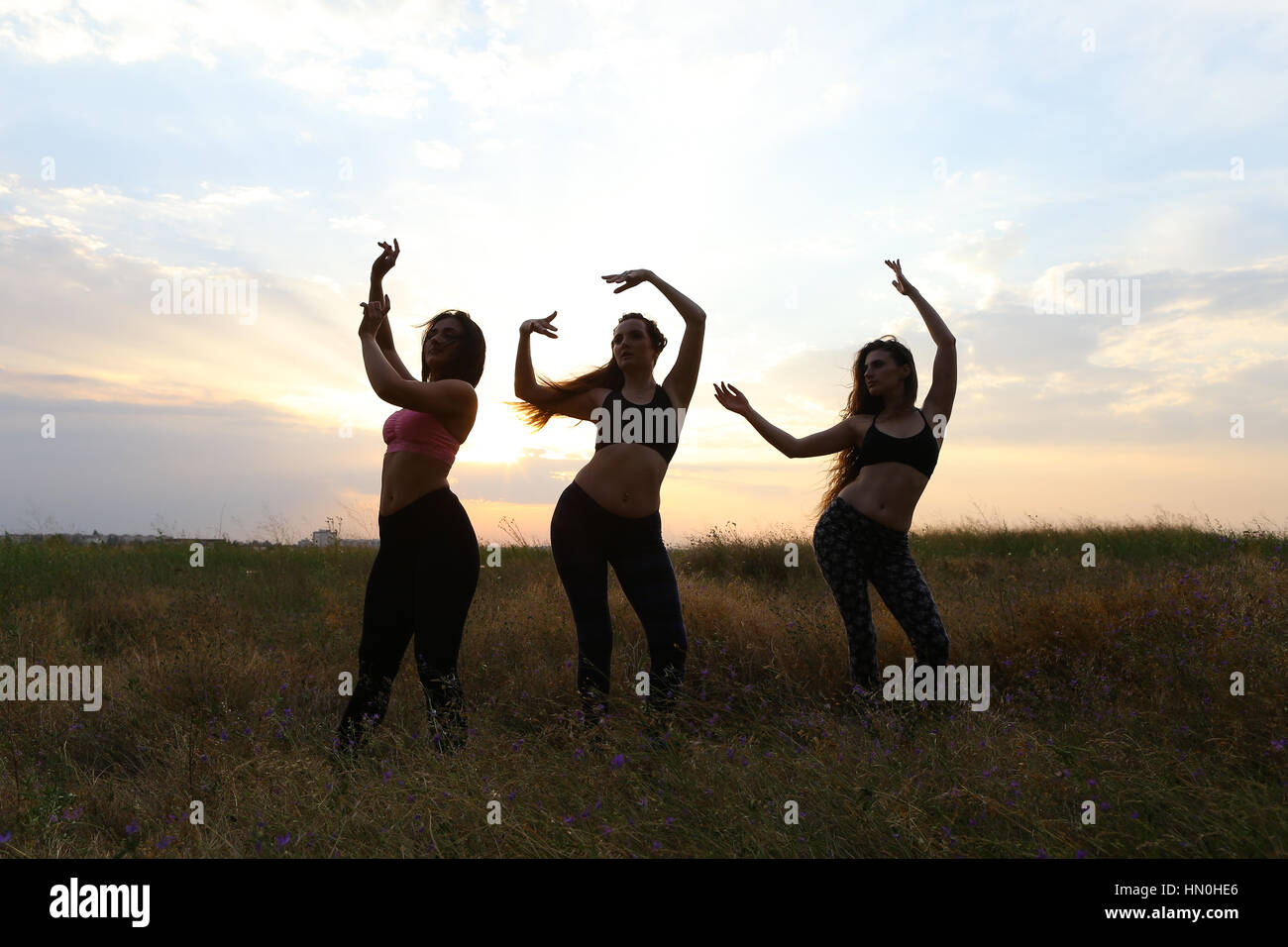 Three beautiful girls dance and show movements of Eastern dance ...