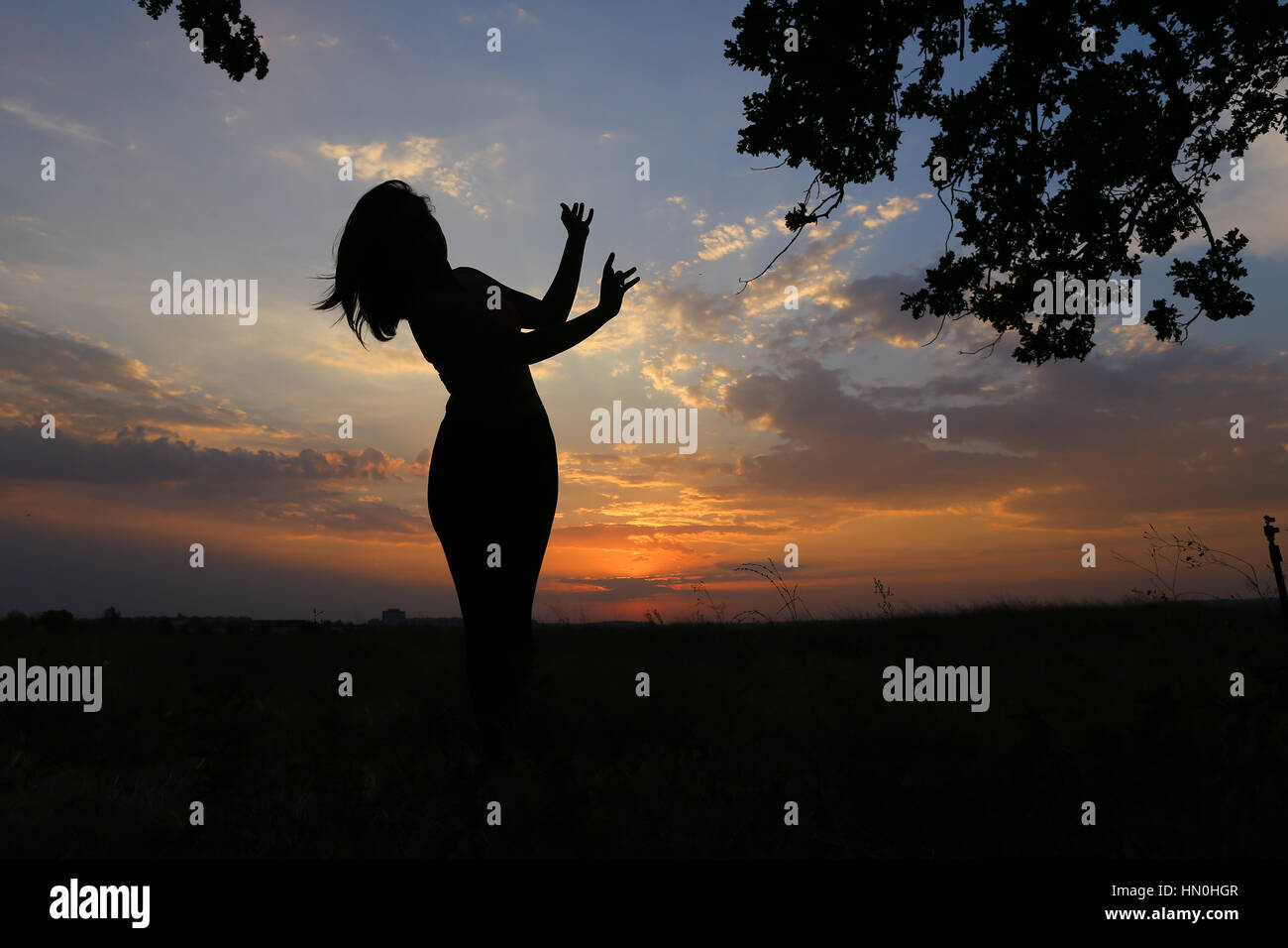 Female with beautiful figure takes yoga postures, gymnastics and ballet ...