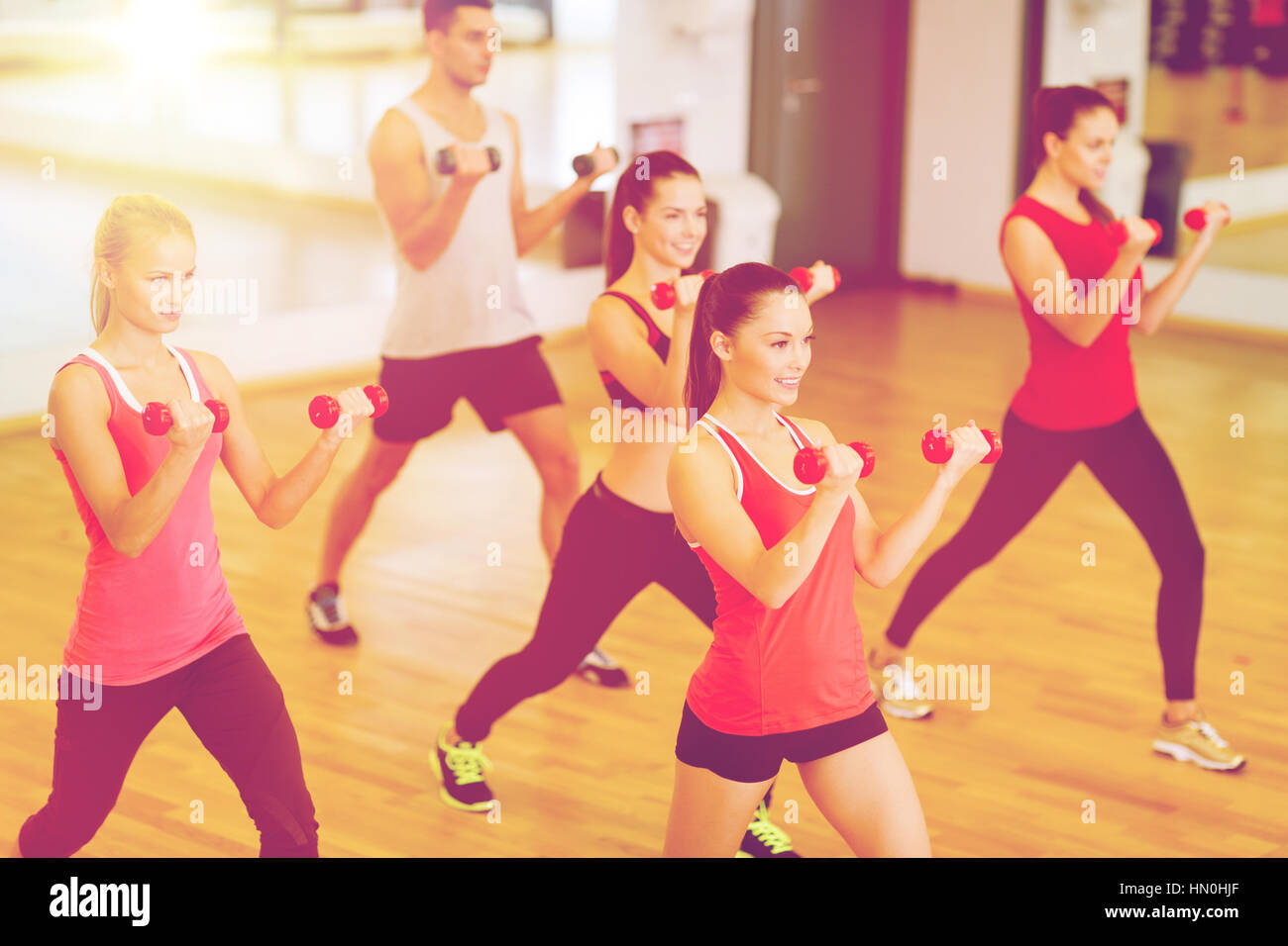 group of smiling people working out with dumbbells Stock Photo - Alamy