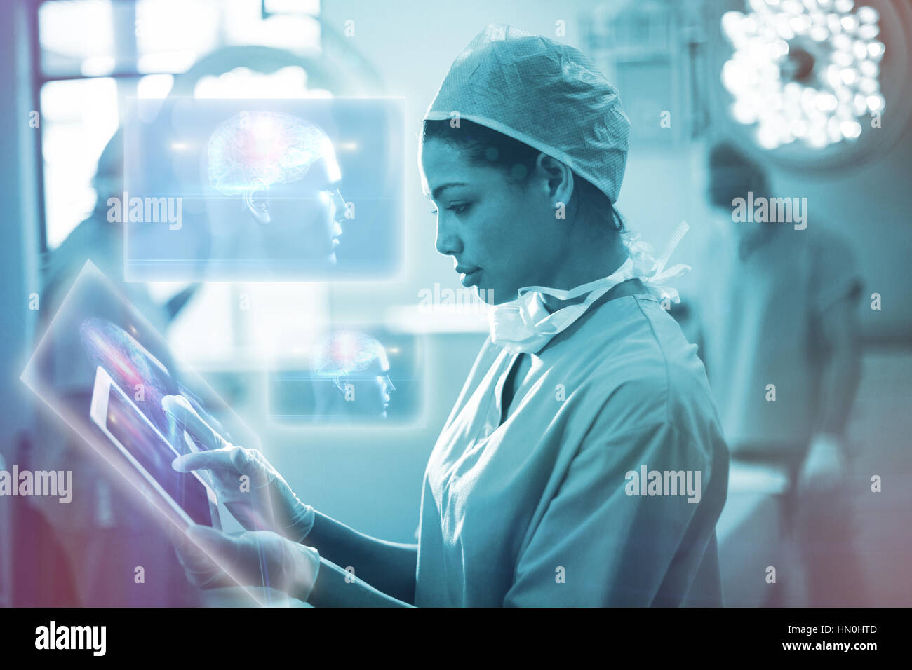Brain diagram in human head against female surgeon using digital tablet ...