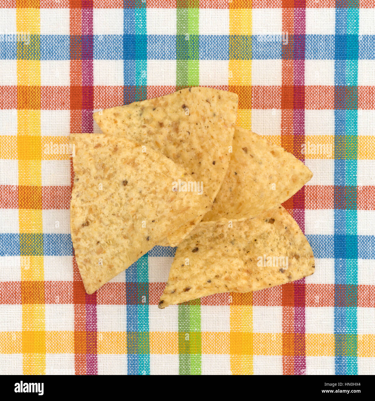 Top view of several tortilla chips on a colorful place mat Stock Photo ...