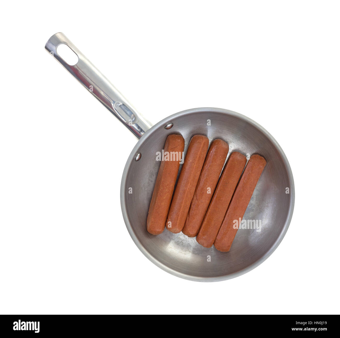 Top view of several uncured beef hot dogs in a frying pan isolated on a ...