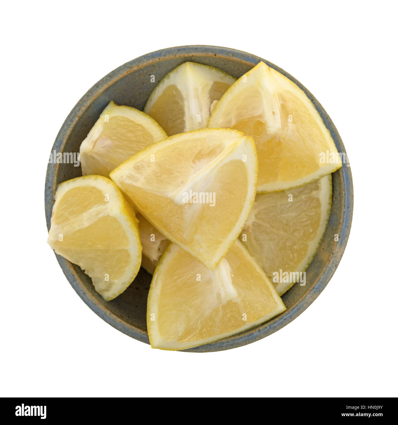 Top view of several chunks of white grapefruit in an old stoneware bowl ...