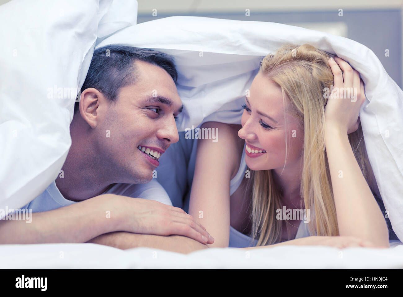 happy couple sleeping in bed Stock Photo - Alamy