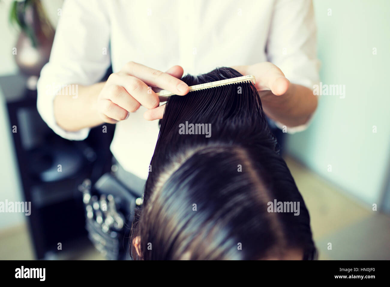 male stylist hands combing wet hair at salon Stock Photo - Alamy