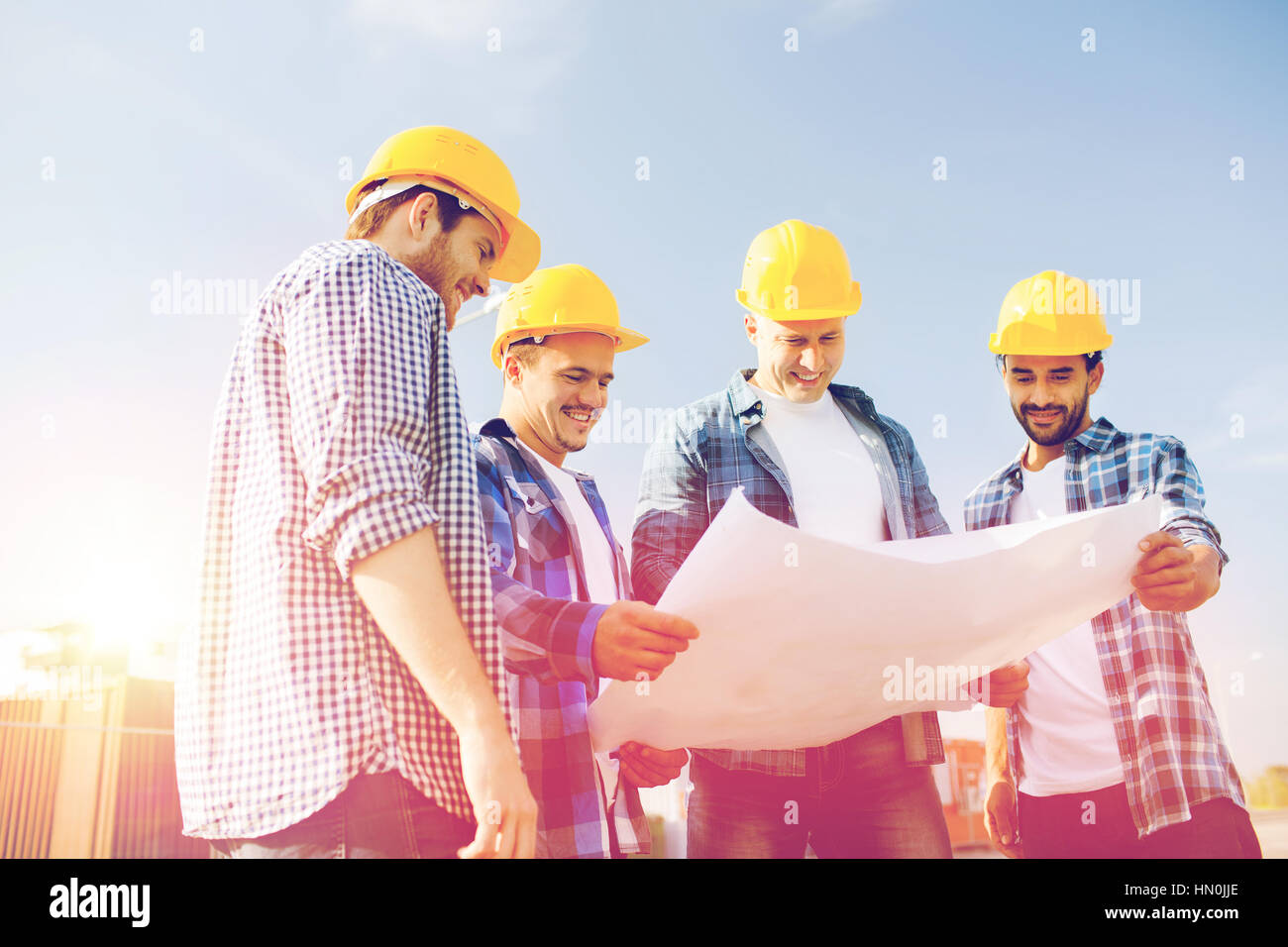 group of builders with tablet pc and blueprint Stock Photo - Alamy