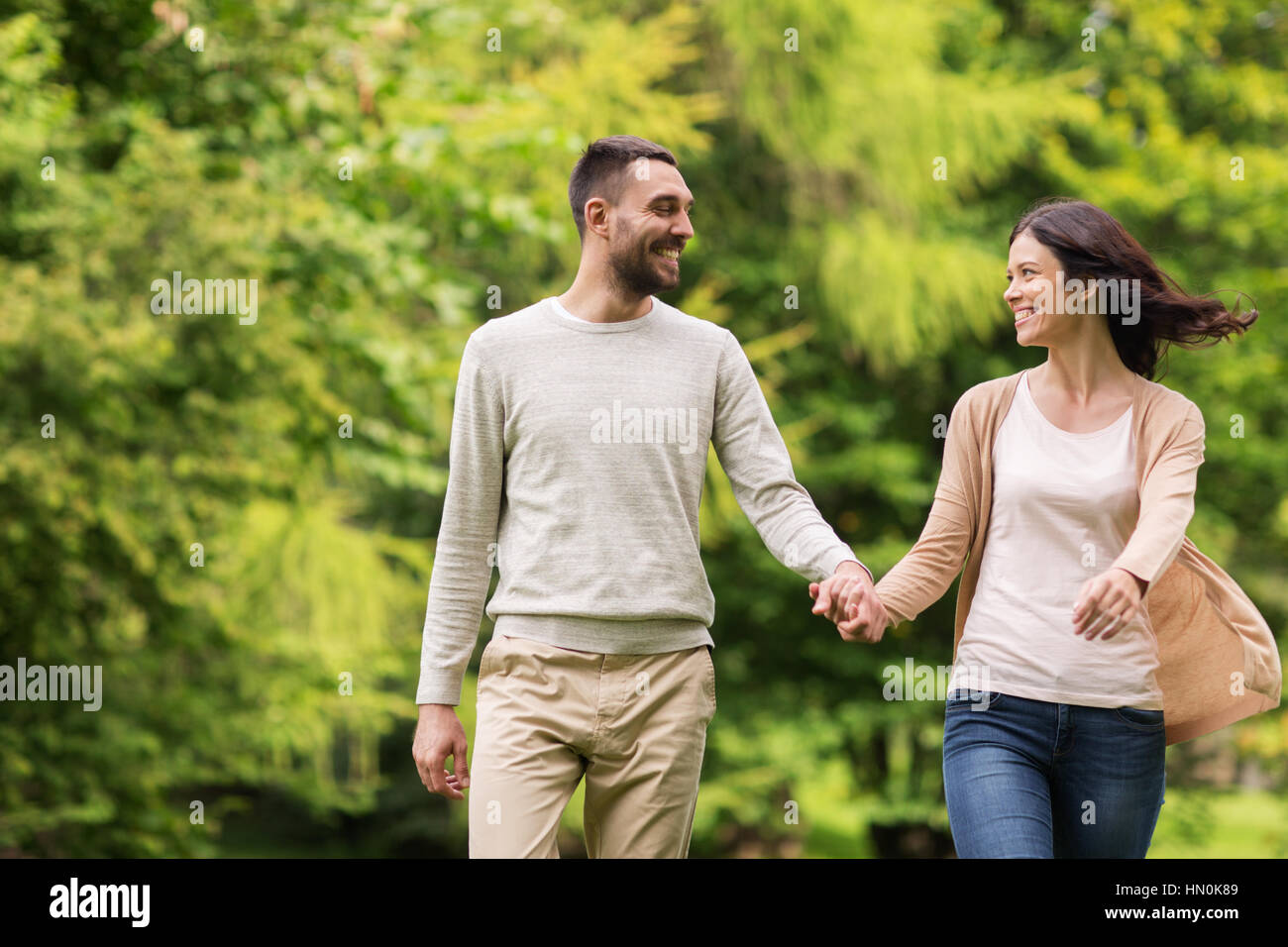 happy couple walking in summer park Stock Photo - Alamy