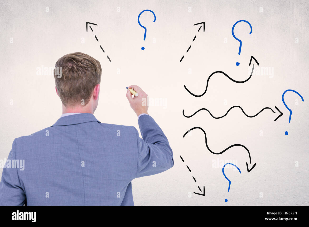 Businessman writing on a white background against white wall Stock ...