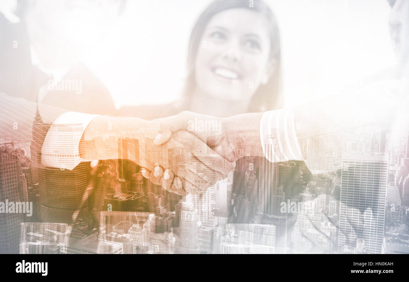 Smiling business people closing a deal against a white background Stock ...