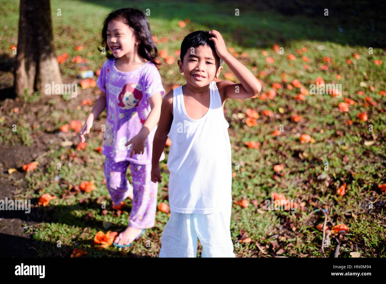 Kids playing at the backyard in the morning Stock Photo - Alamy