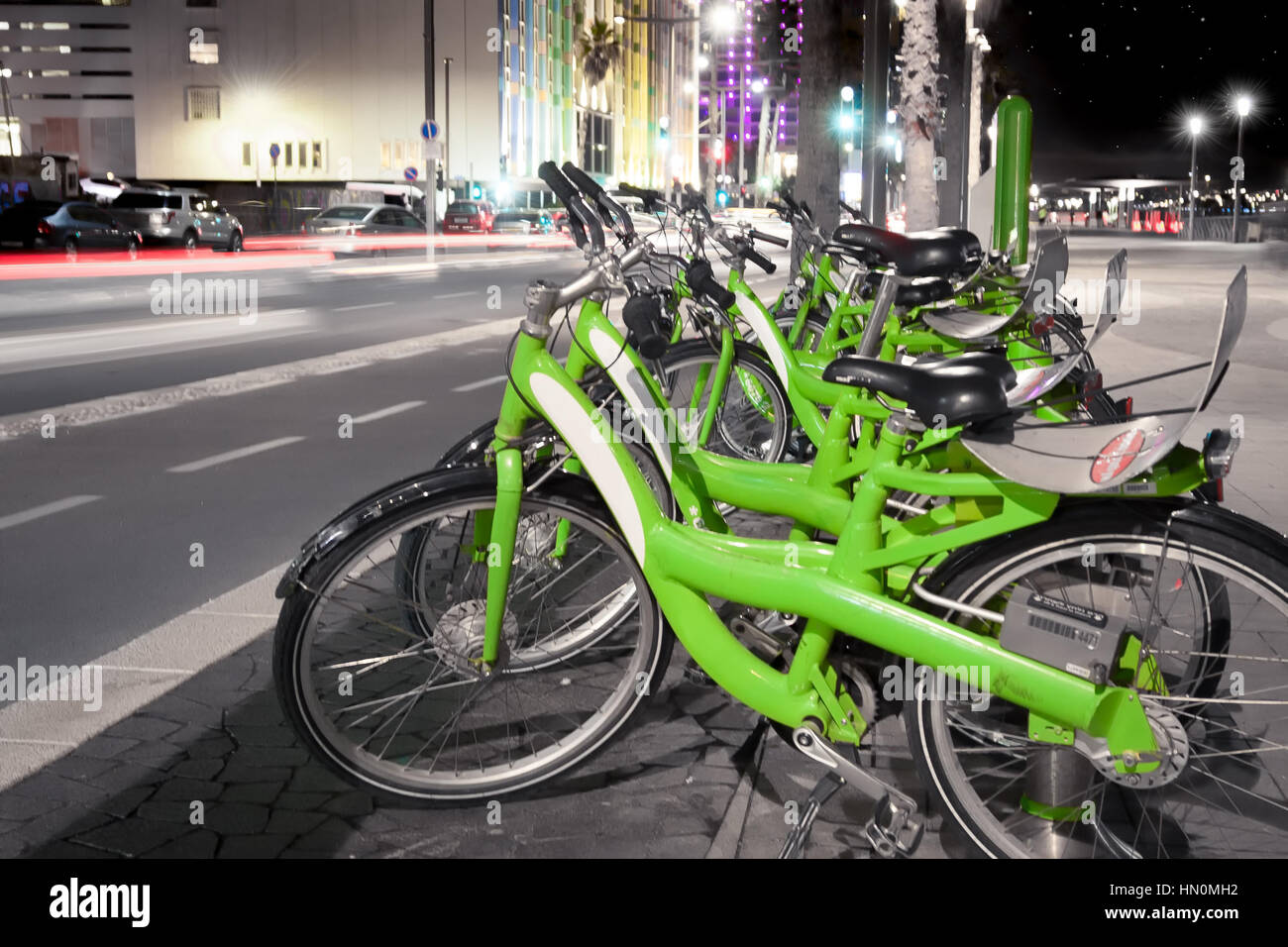 Green bicycles parked at night - city streets - Tel Aviv, Israel Stock ...