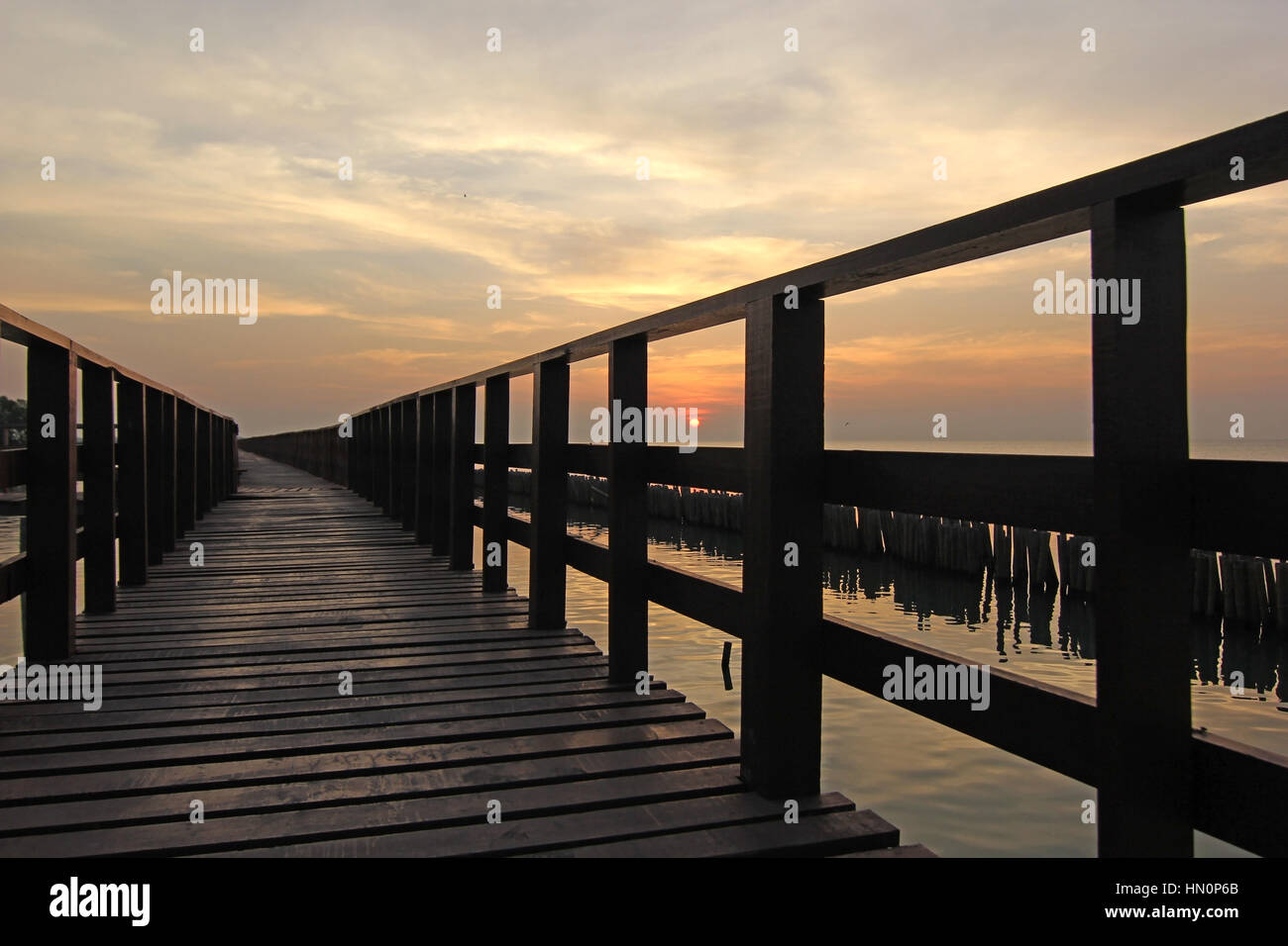wooden jetty on seaside with beautiful sunrise background Stock Photo ...