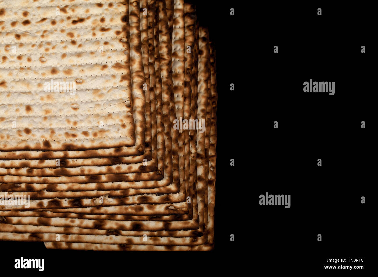 Traditional Jewish matzah on a black background. Close-up Stock Photo ...