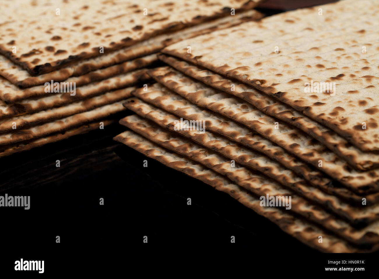 Traditional Jewish matzah on a black background. Close-up Stock Photo ...