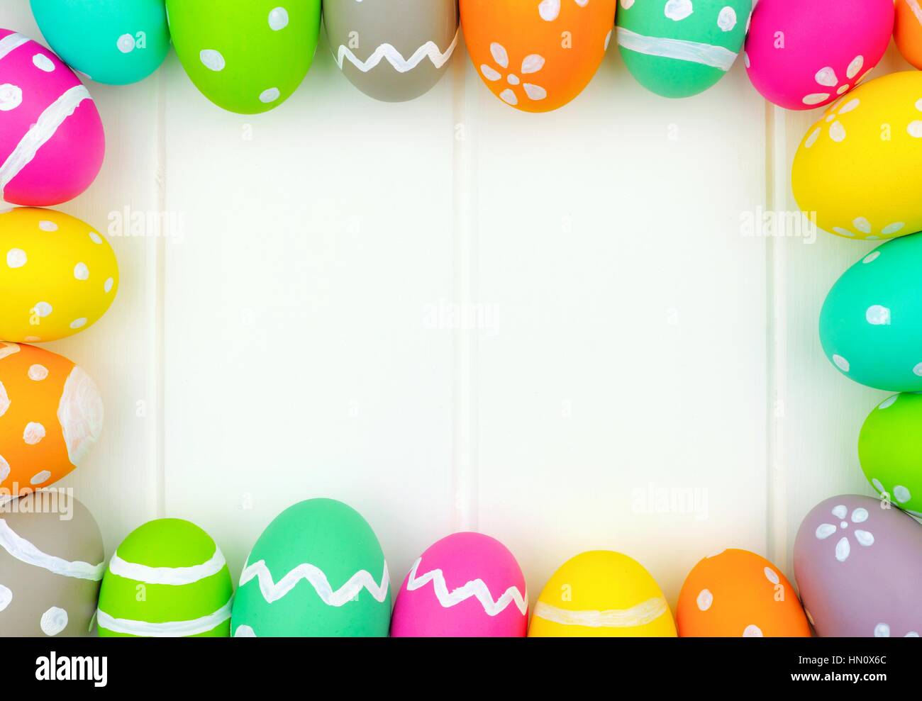 Colorful Easter egg frame around a white wood background Stock Photo ...