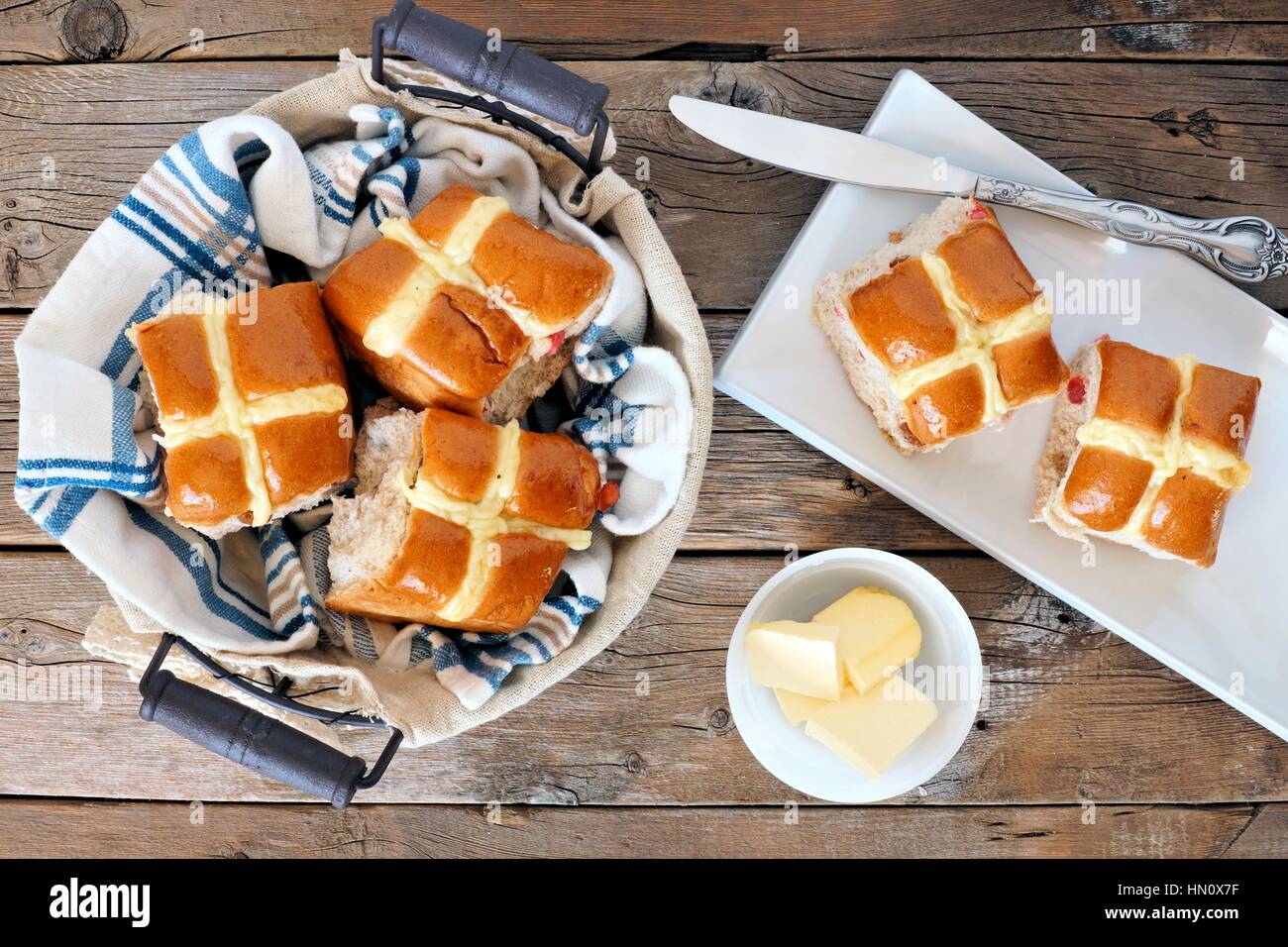 Easter Hot Cross Buns, overhead scene with basket and plate on rustic ...