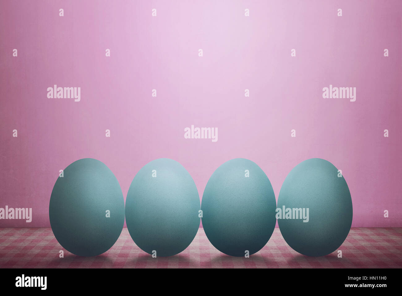 Row of easter eggs on desk against pink background Stock Photo - Alamy