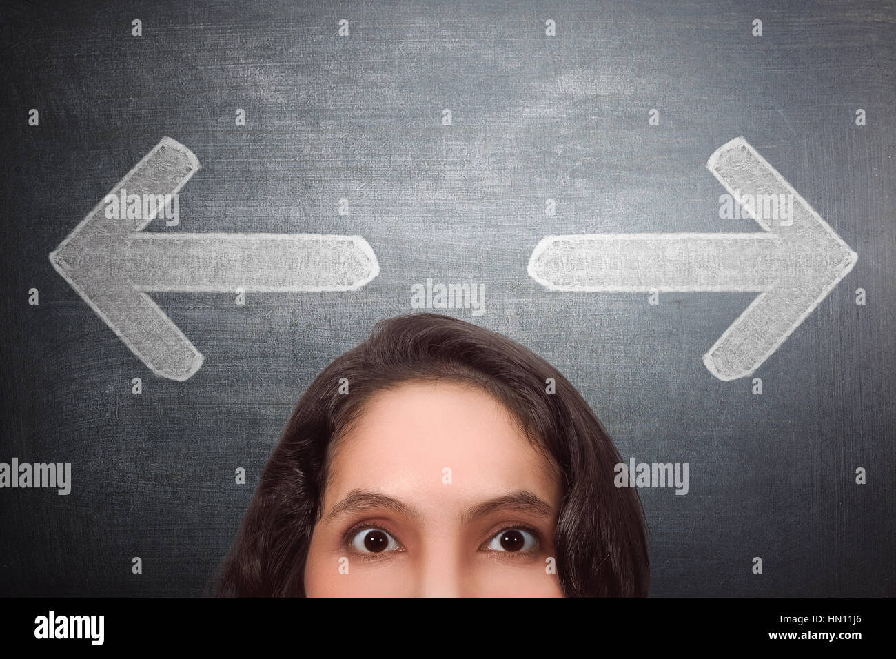 Confusing asian woman with arrow signal on head against black ...