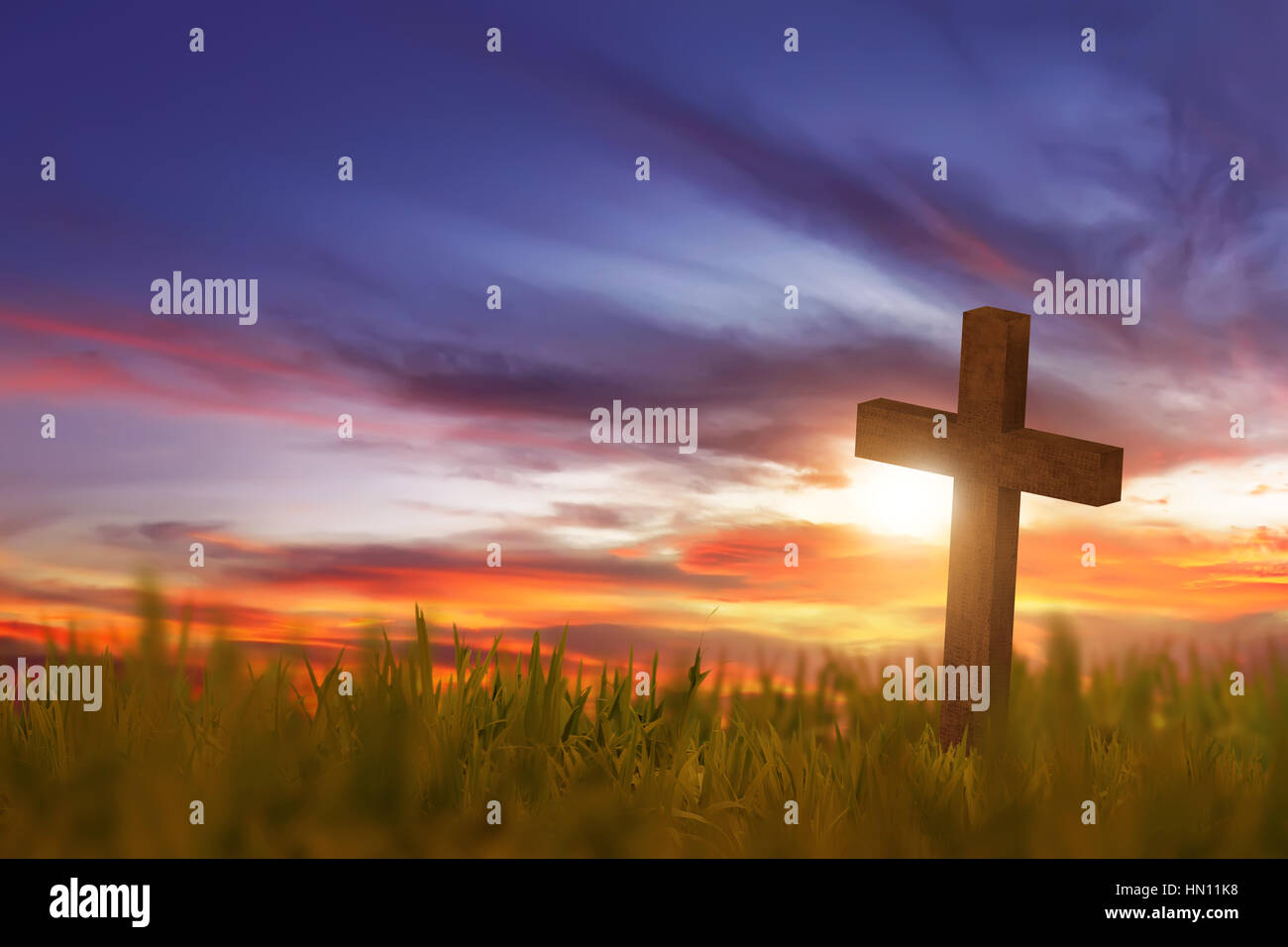 Wooden cross on green grass with sunset in the sky background Stock ...