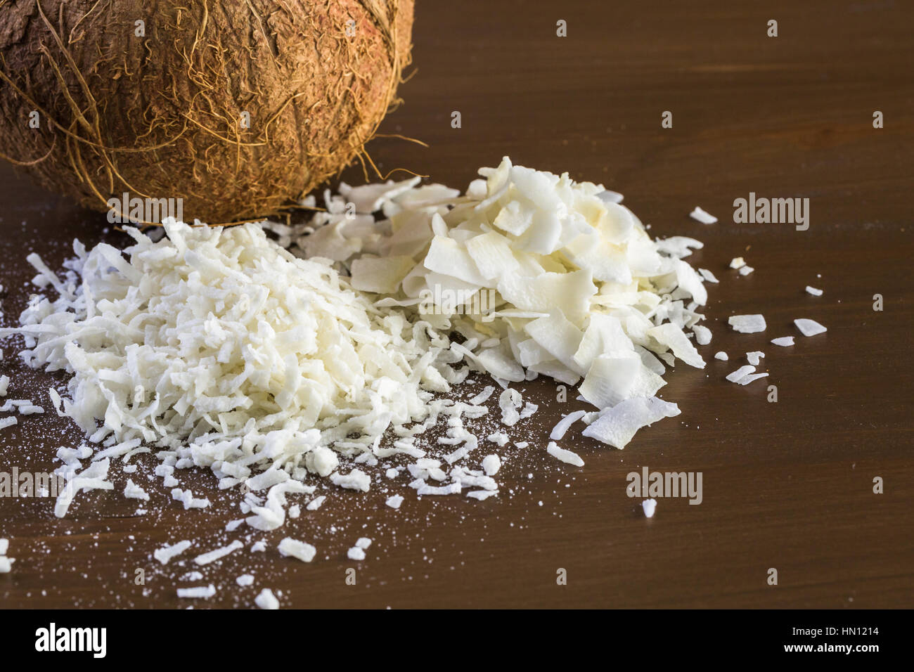 Dehydrated coconut flakes on a wood background Stock Photo - Alamy