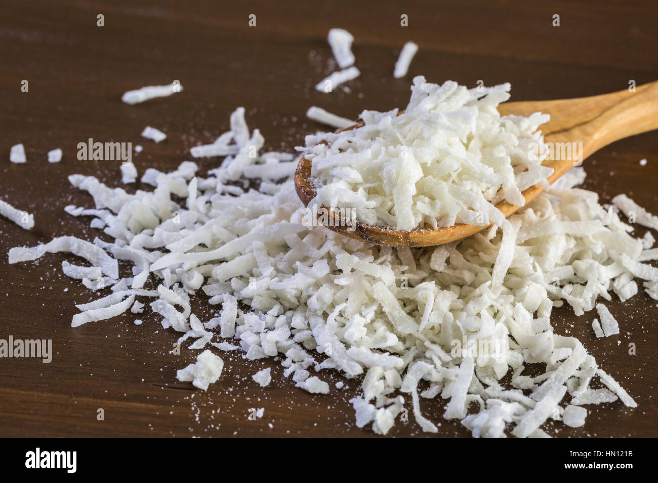 Dehydrated coconut flakes on a wood background Stock Photo - Alamy