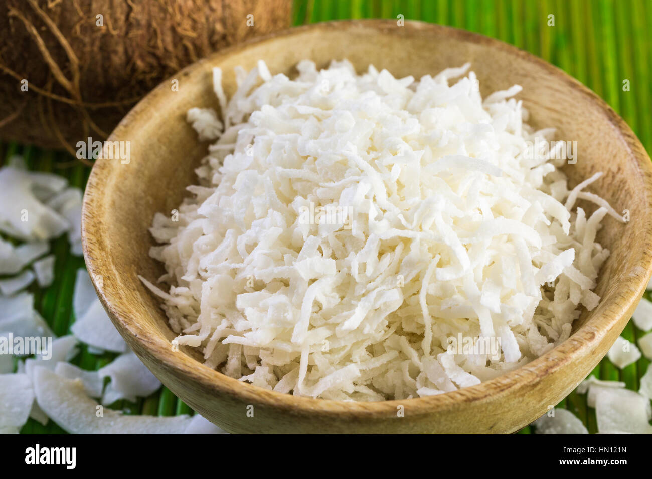 Dehydrated coconut flakes in wooden bowl Stock Photo - Alamy