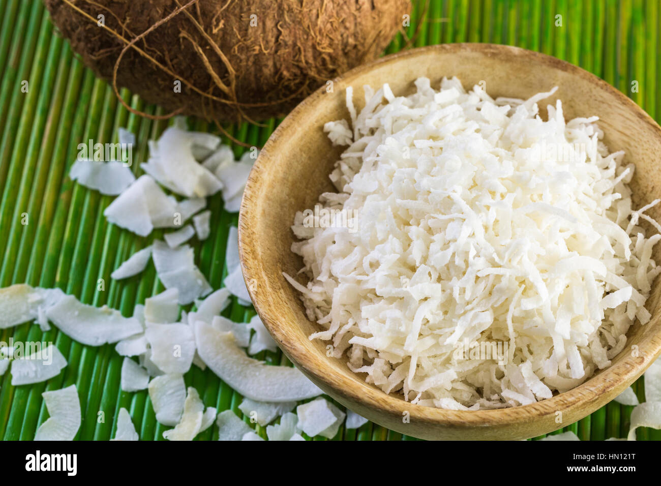 Dehydrated coconut flakes in wooden bowl Stock Photo - Alamy