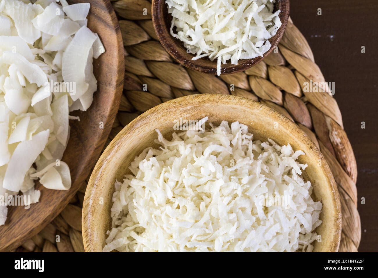 Dehydrated coconut flakes in wooden bowl Stock Photo - Alamy