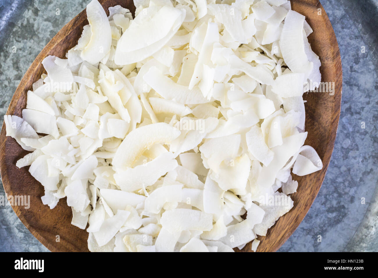 Dehydrated coconut flakes in wooden bowl Stock Photo - Alamy