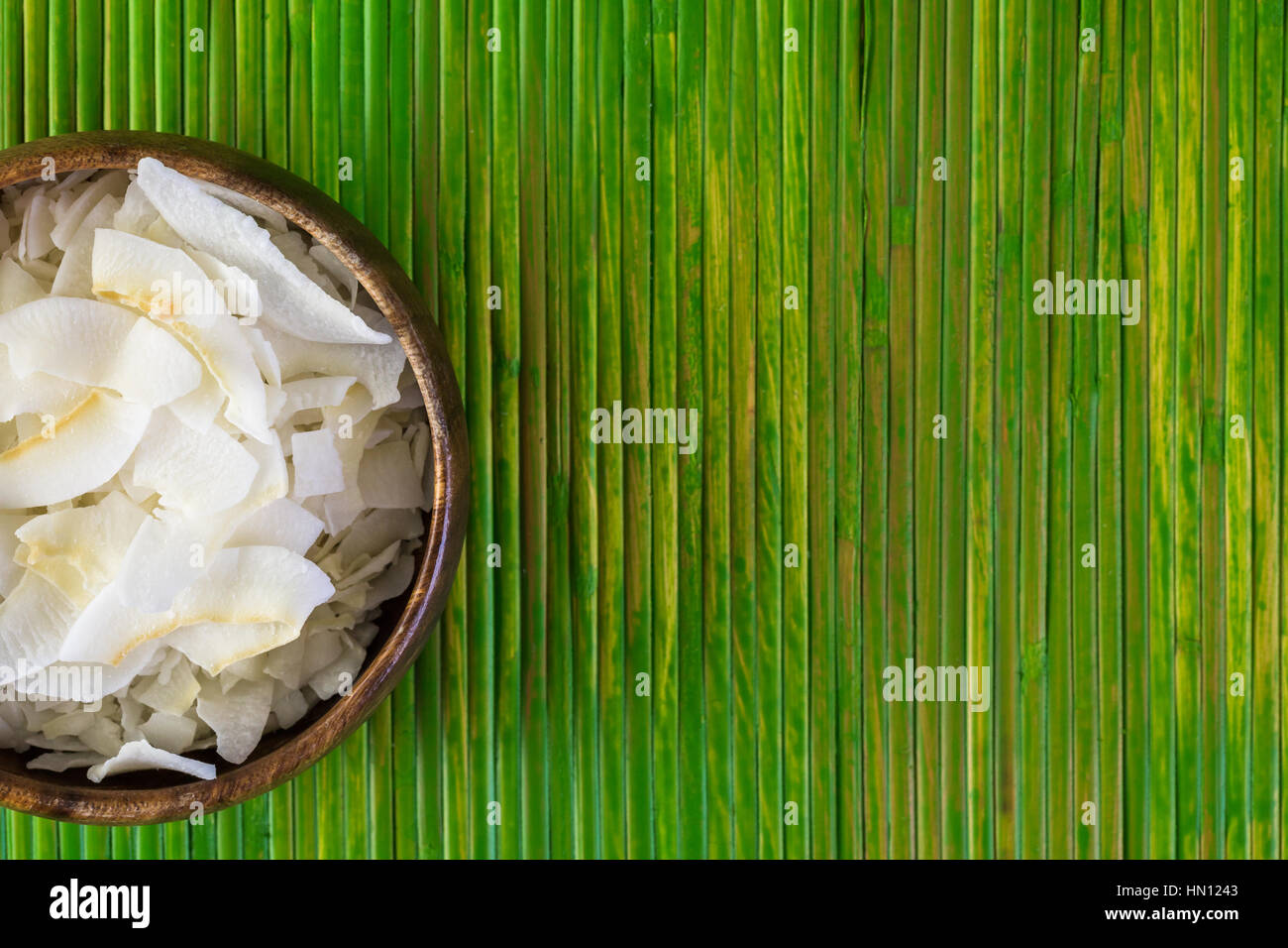 Dehydrated coconut flakes in wooden bowl Stock Photo - Alamy