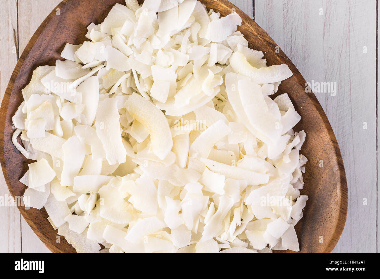 Dehydrated coconut flakes in wooden bowl Stock Photo - Alamy