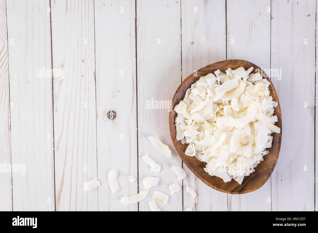 Dehydrated coconut flakes in wooden bowl Stock Photo - Alamy