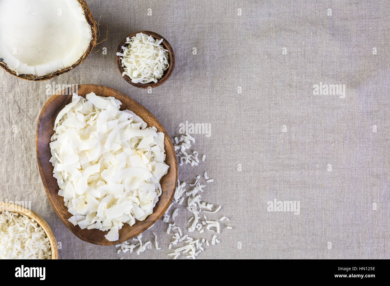 Dehydrated coconut flakes in wooden bowl Stock Photo - Alamy