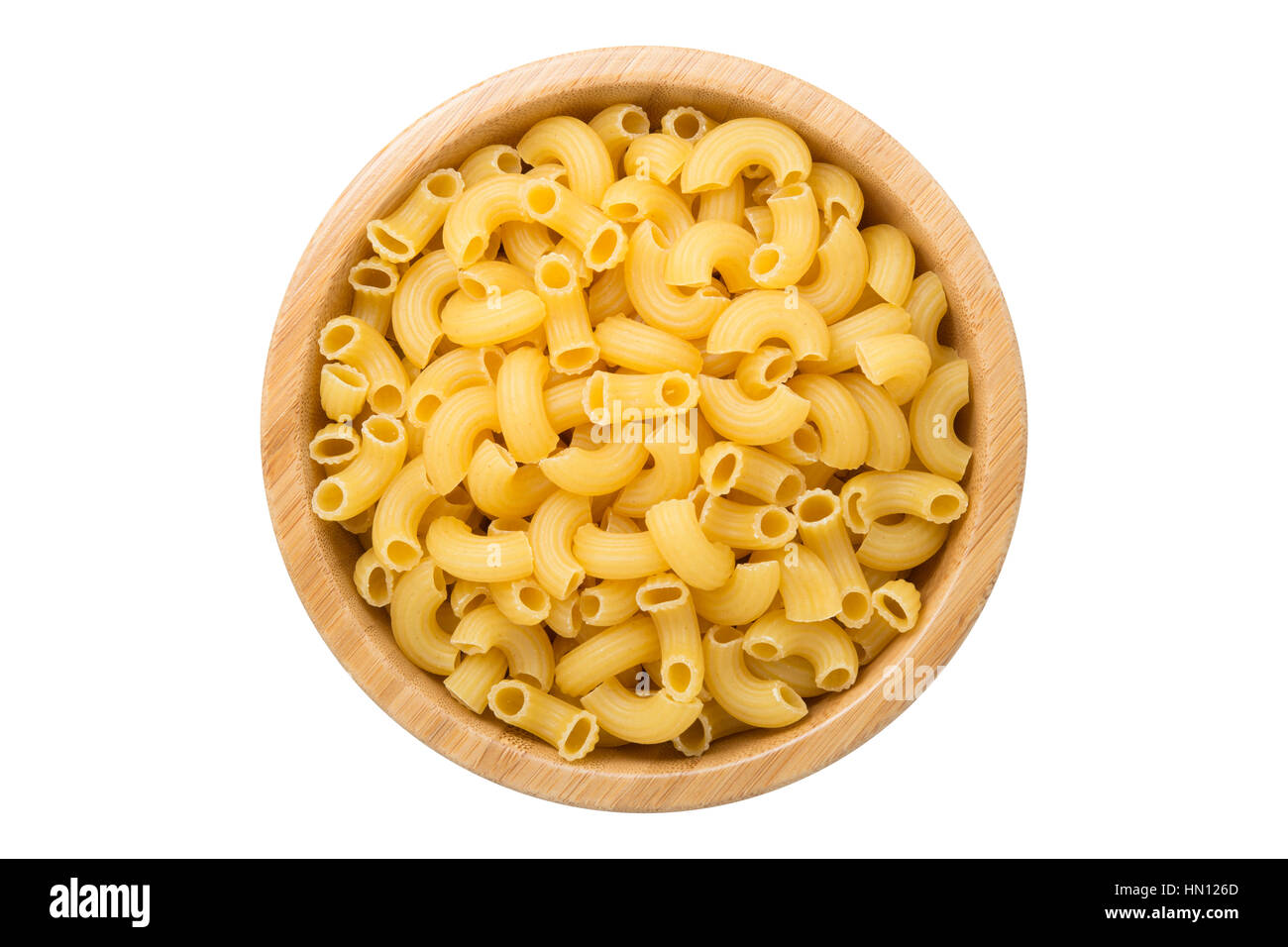 Top view of uncooked macaroni pasta in wooden bowl isolated on white ...