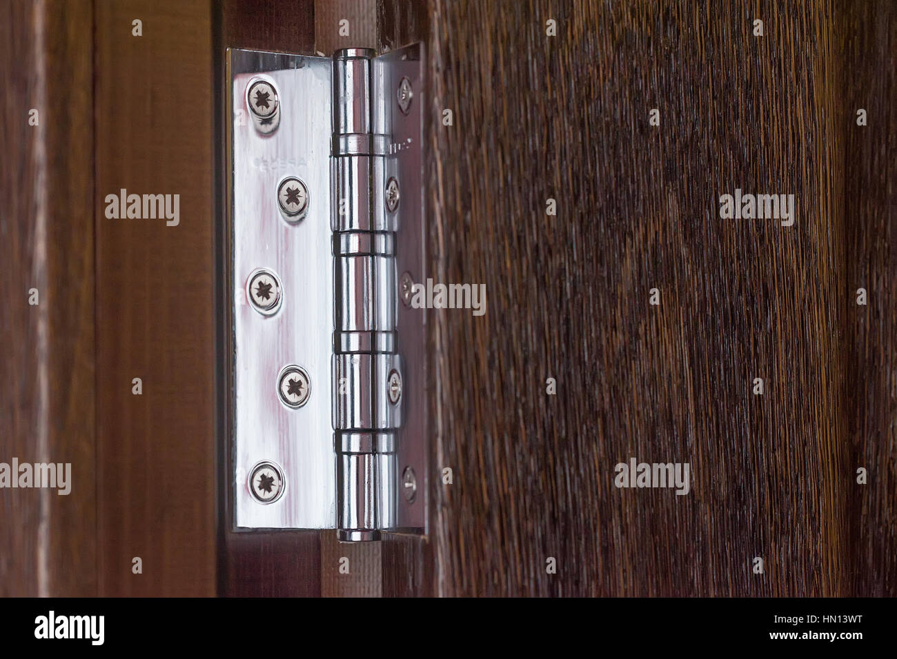 Close-up new modern door hinge on wooden door Stock Photo - Alamy