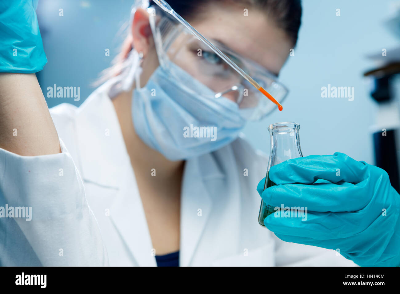 Laboratory assistant in mask and goggles at chemistry lab Stock Photo ...