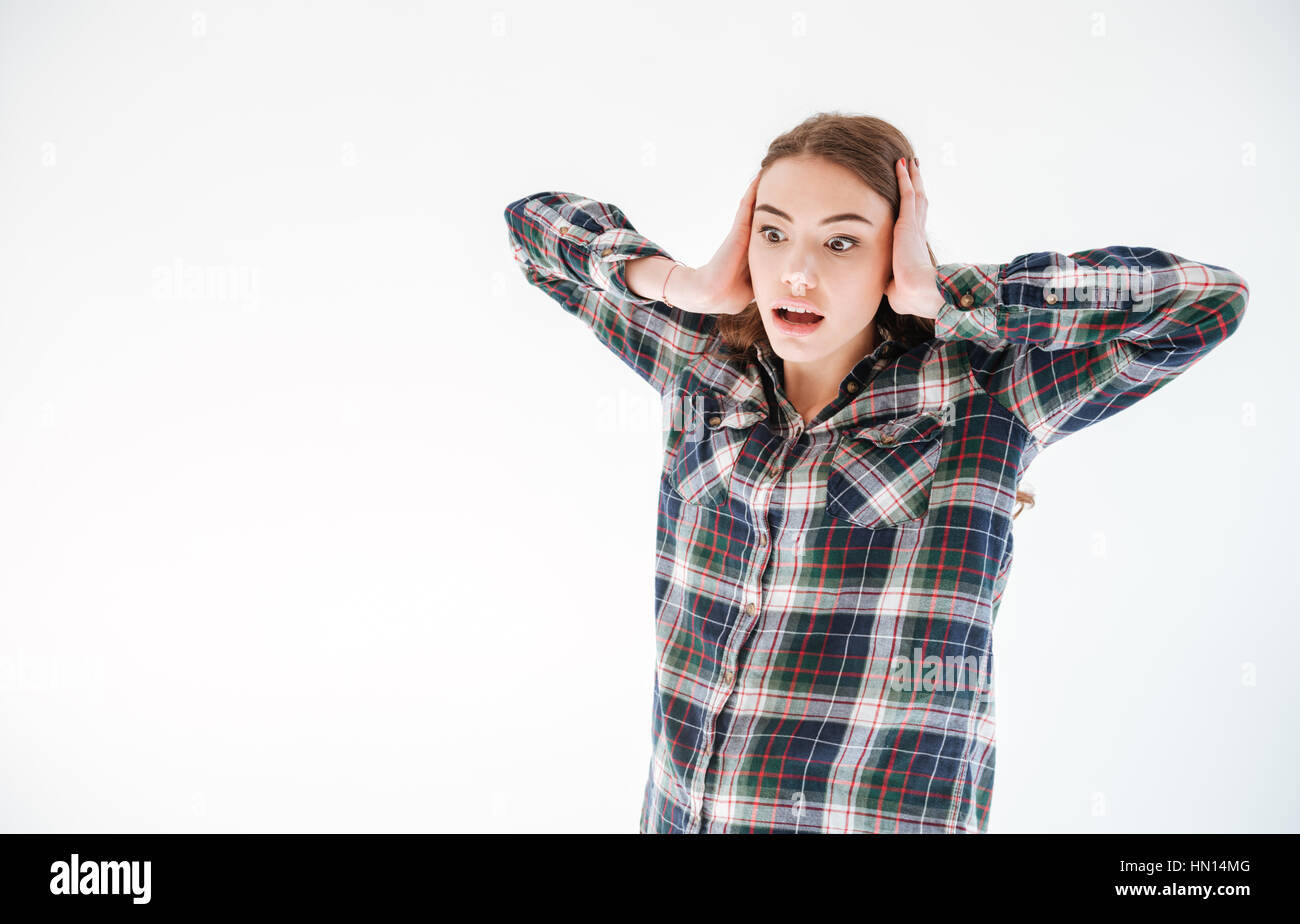 Scared frightened young woman in plaid shirt standing and screaming ...